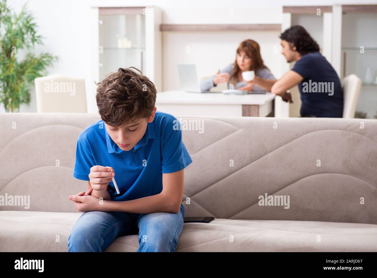 The concept of underage smoking with young boy and family Stock Photo ...