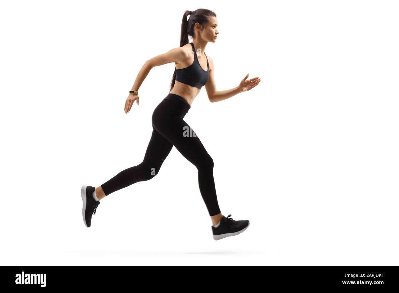 Full length profile shot of an active young woman running fast isolated ...