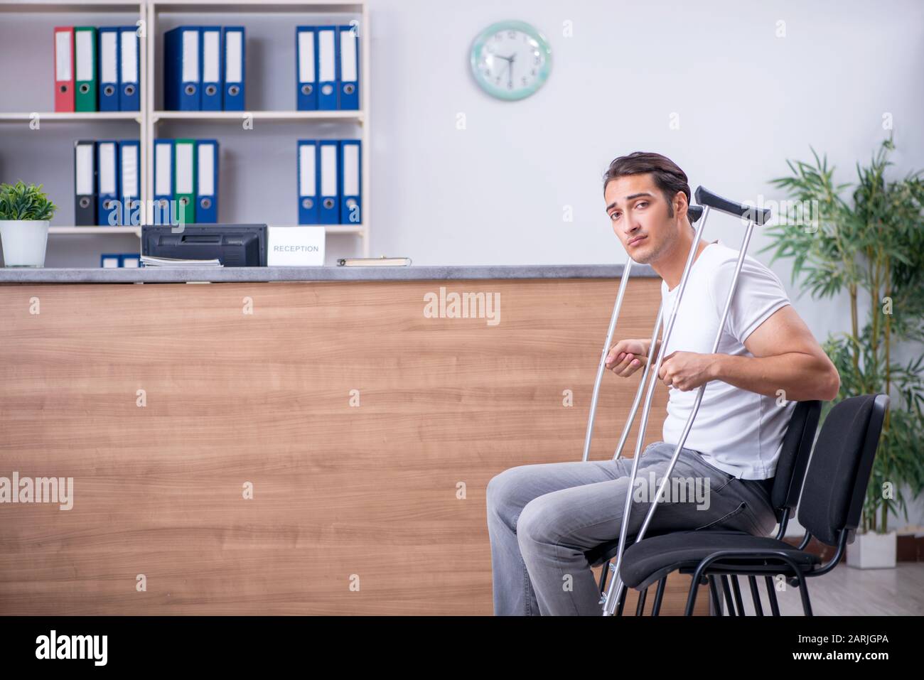 Clinic reception counter and young patient Stock Photo - Alamy
