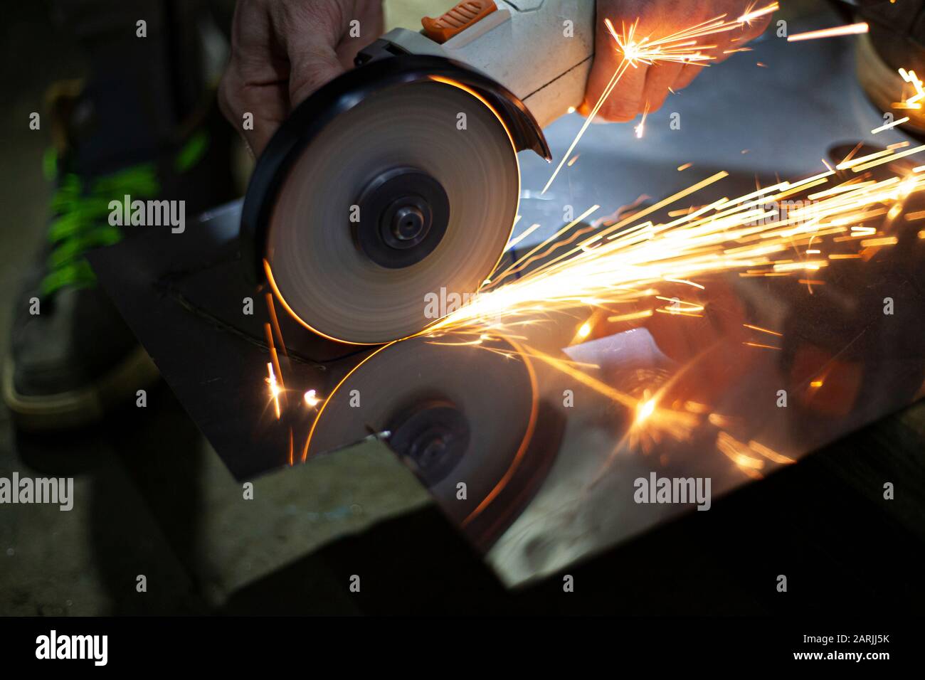 Metal cutting. Grinding steel. Work as a grinder. Sparks from friction ...