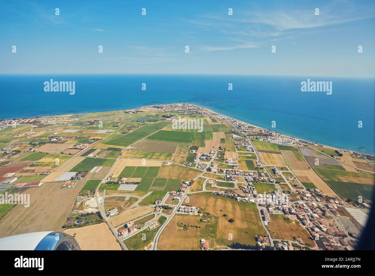 The plane is flying over the island of Cyprus. Airplane wing in flight ...