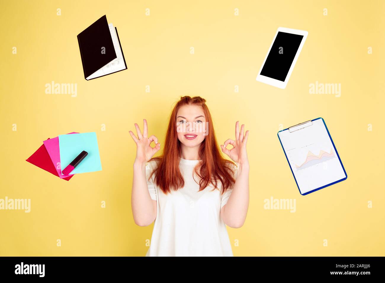 Showing nice. Caucasian young woman's portrait on yellow studio ...