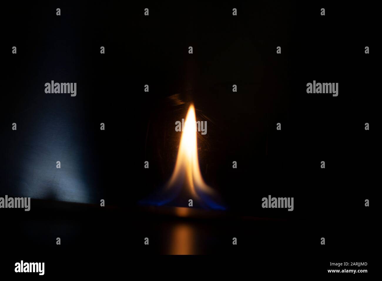 Tongue of fire flame in the dark. Ignition of oxygen in space. Fiery background. Fire of ether ...