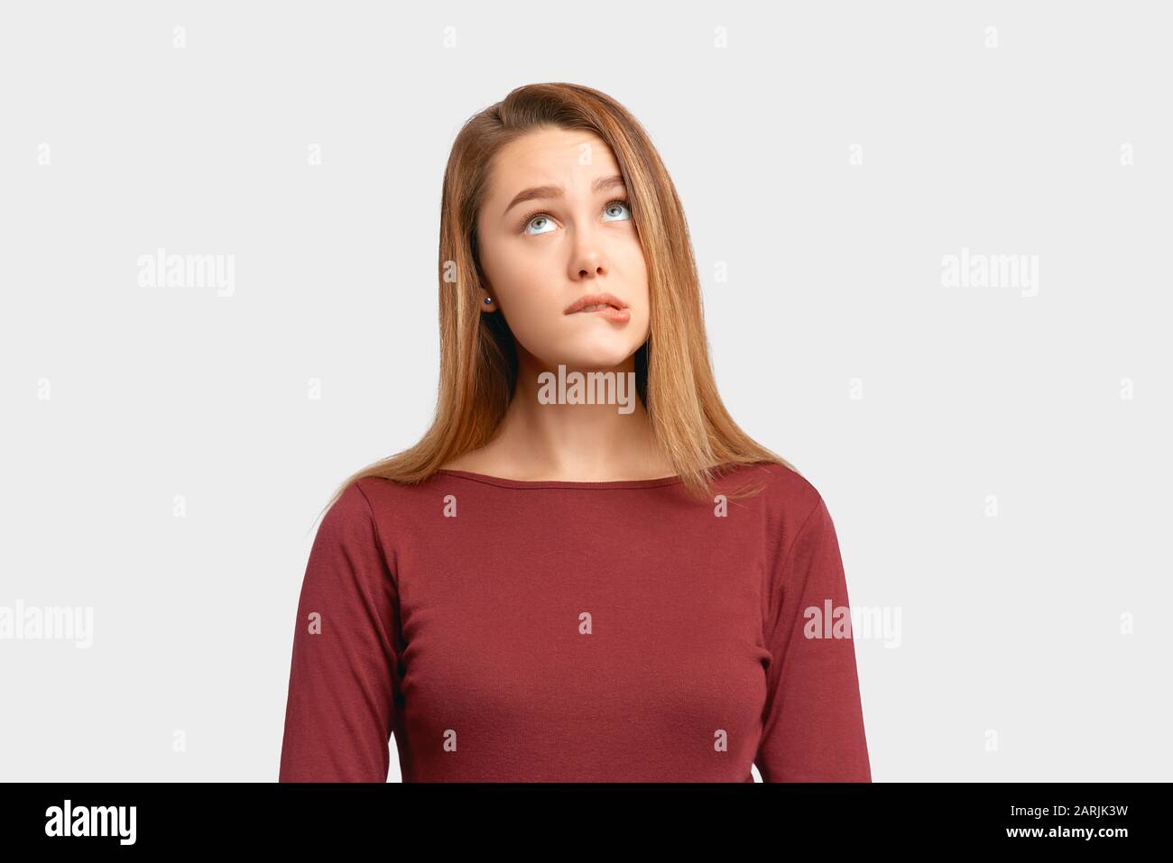 Portrait girl confused frightened look bite lip Stock Photo - Alamy