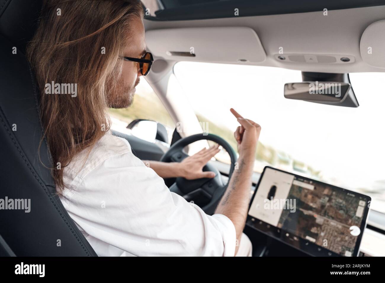 Mode of Transport. Man with long hair in sunglasses traveling sitting ...