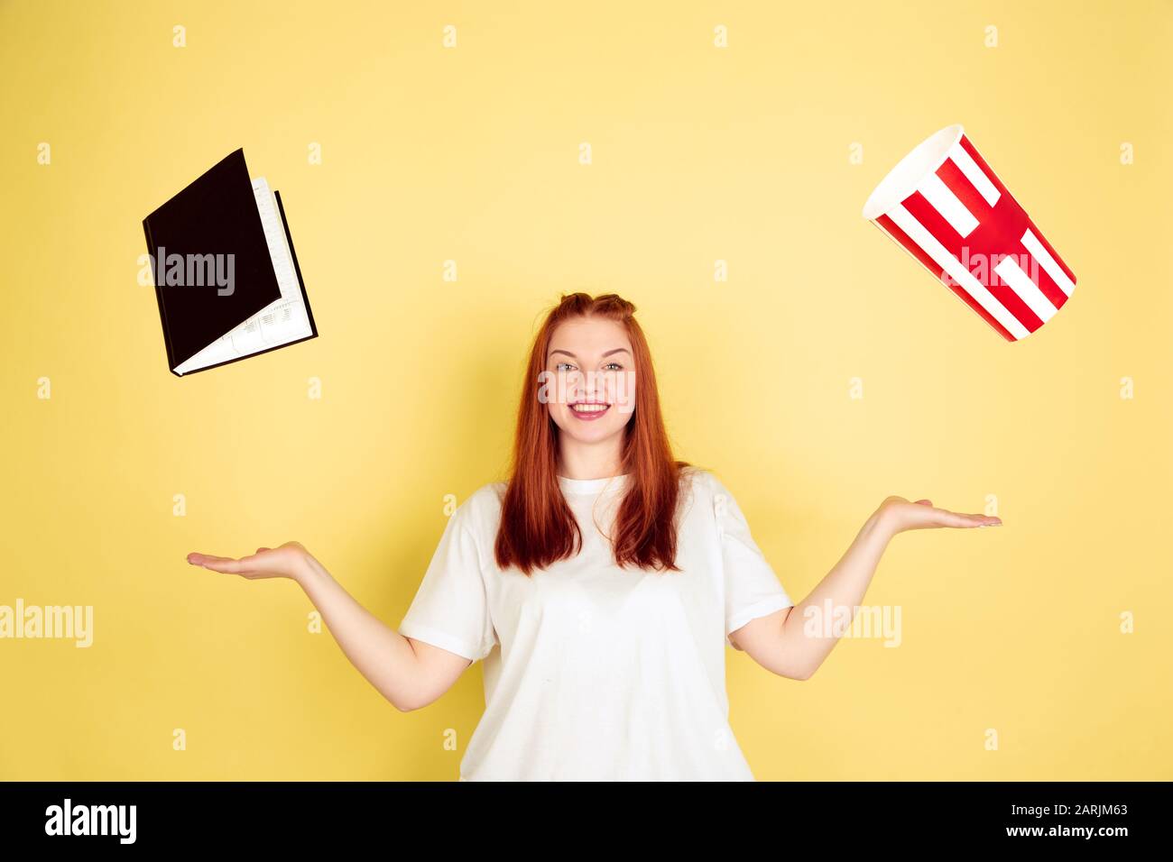 Showing, inviting. Caucasian young woman's portrait on yellow studio ...