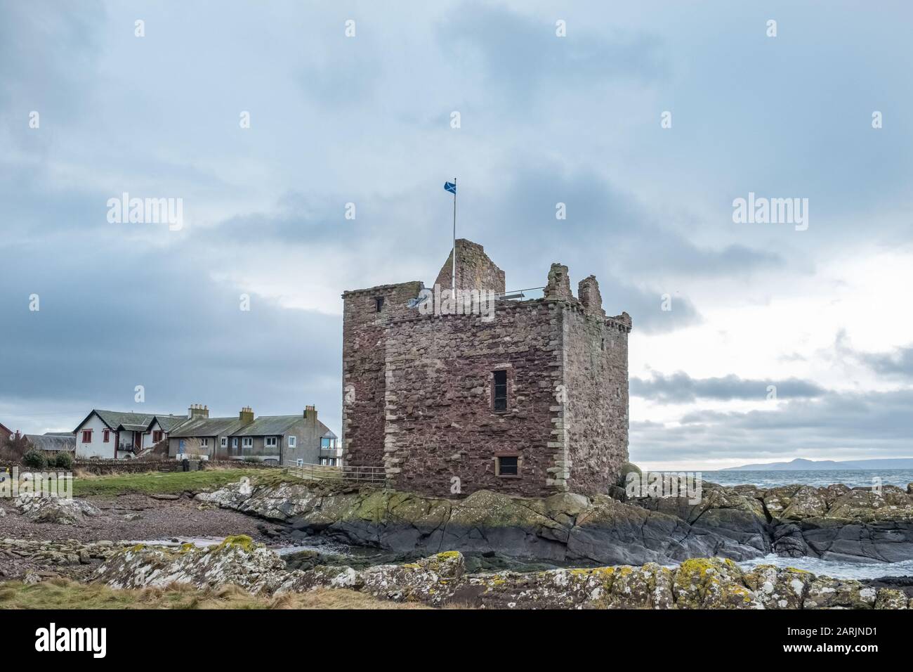 The ruins of old Portencross Castle while the Scottish Saltire Flag is ...
