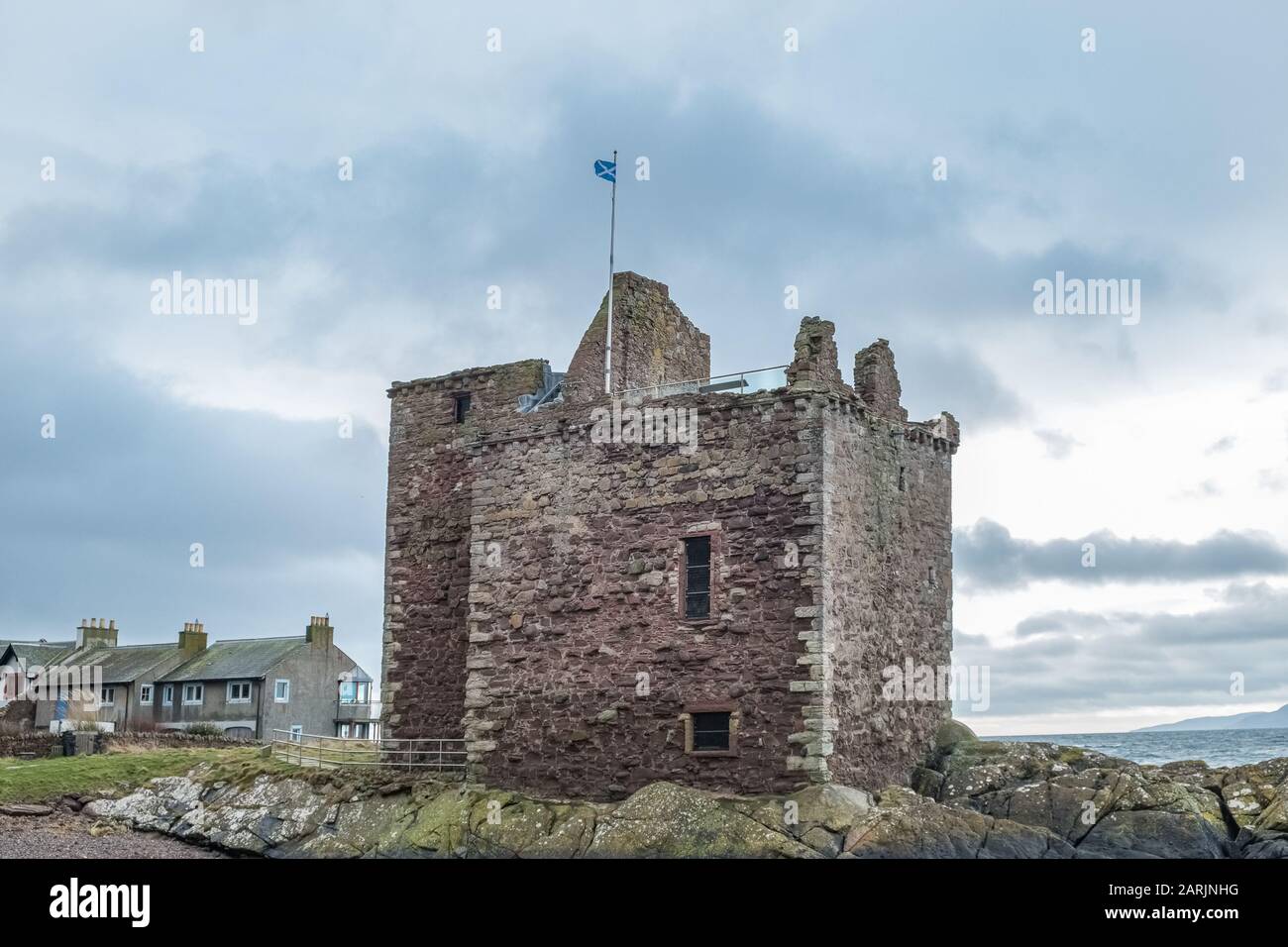 The ruins of old Portencross Castle while the Scottish Saltire Flag is ...