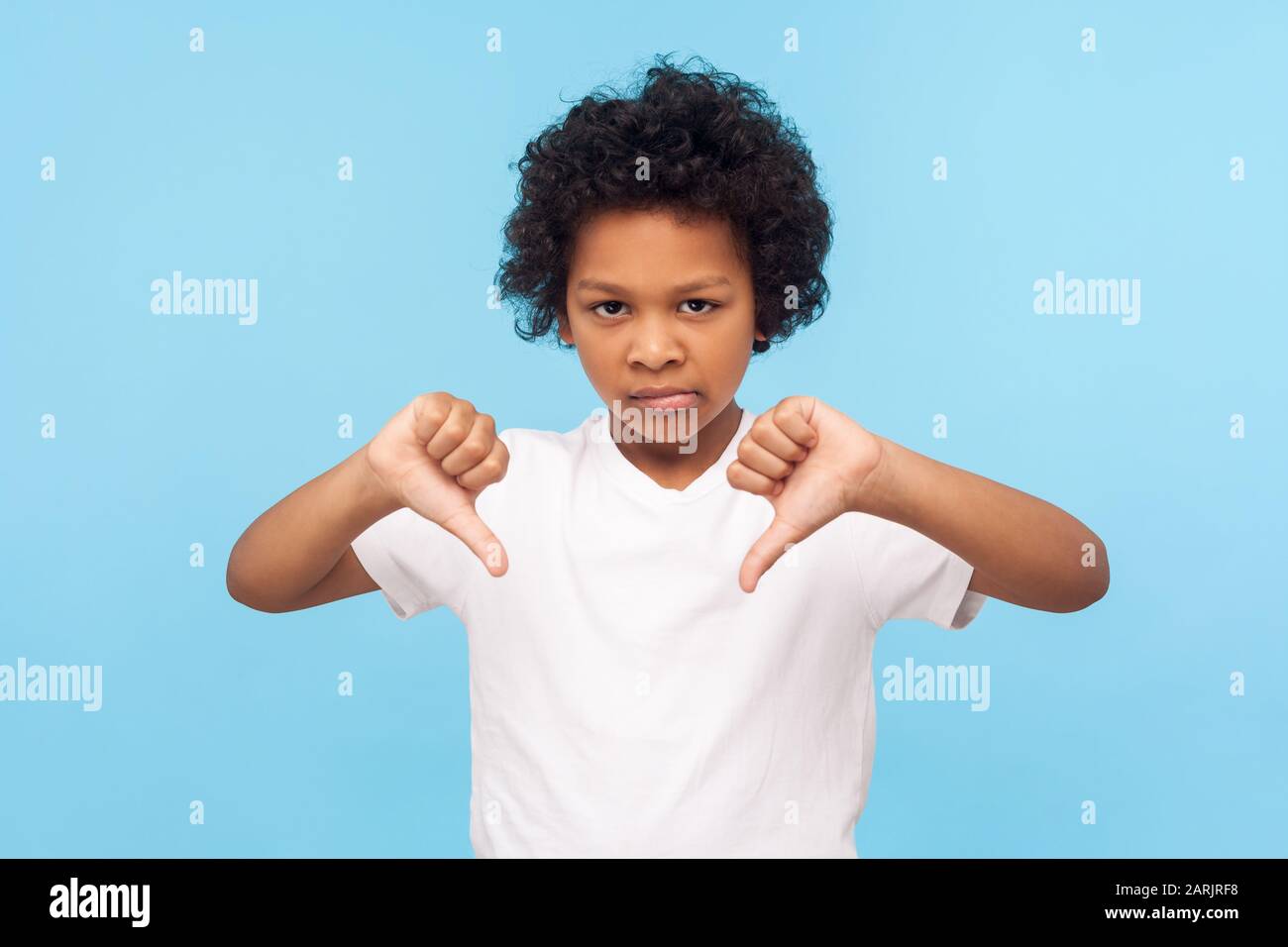 Dislike! Portrait of dissatisfied upset little boy with curly hair ...