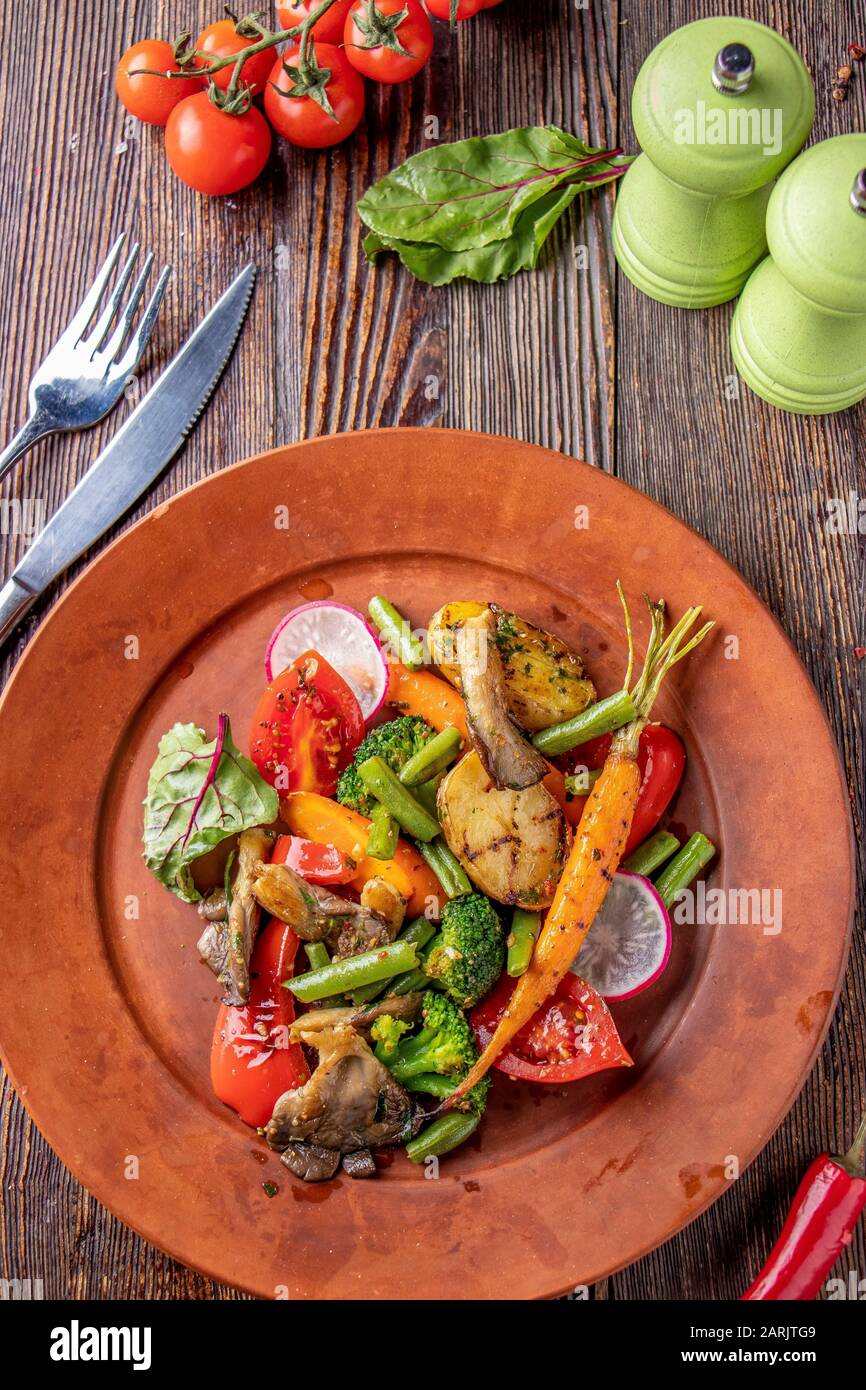 Vegetarian food, side dish of baked vegetables and mushrooms ...