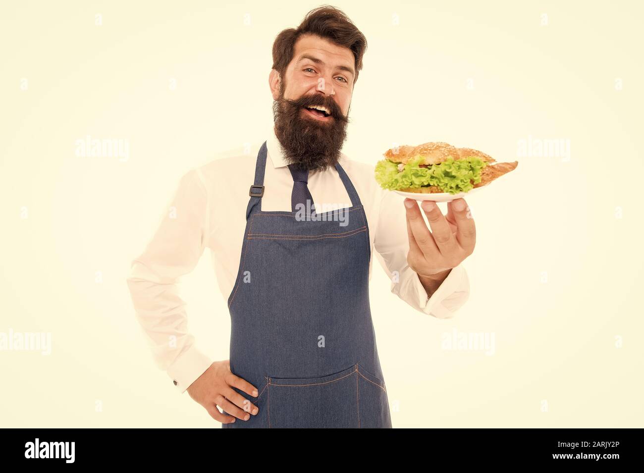 Enjoy your meal. Happy cook hold cooked meal. Bearded man smile with ...
