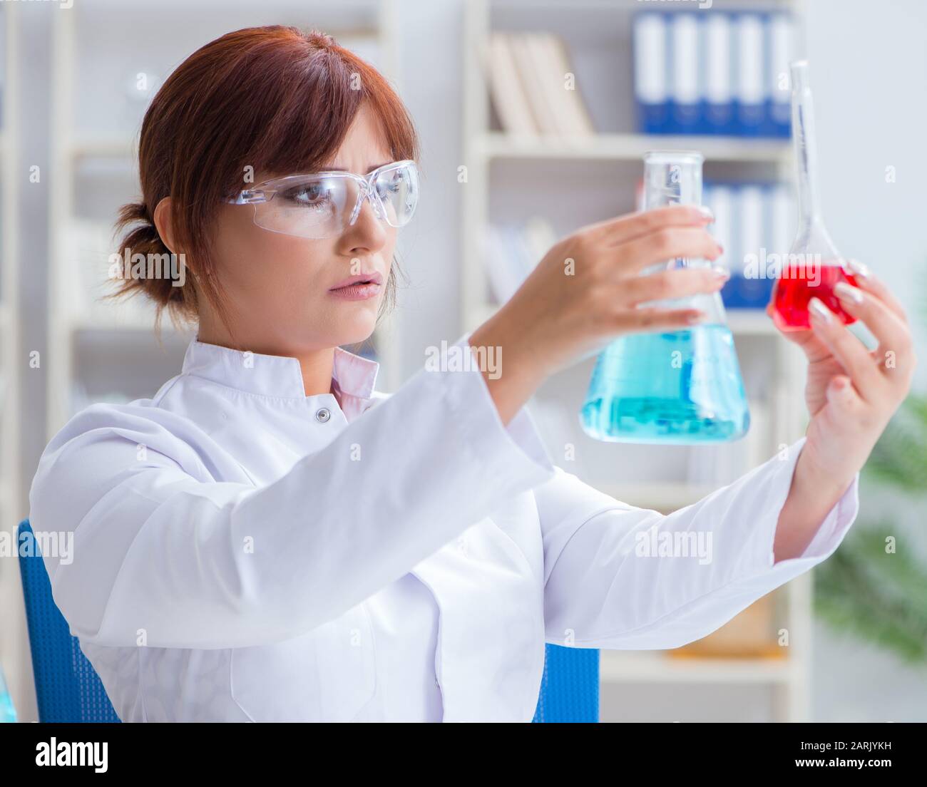 Female scientist researcher conducting an experiment in a laboratory ...