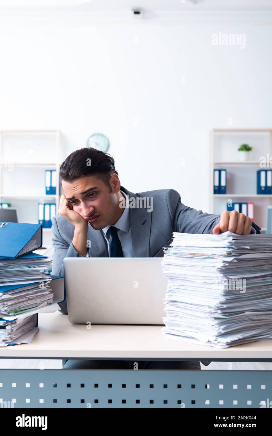 The businessman with heavy paperwork workload Stock Photo - Alamy