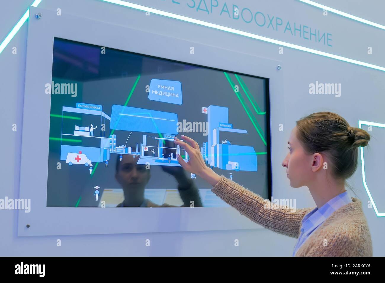 Woman using multimedia touchscreen display of interactive kiosk Stock ...