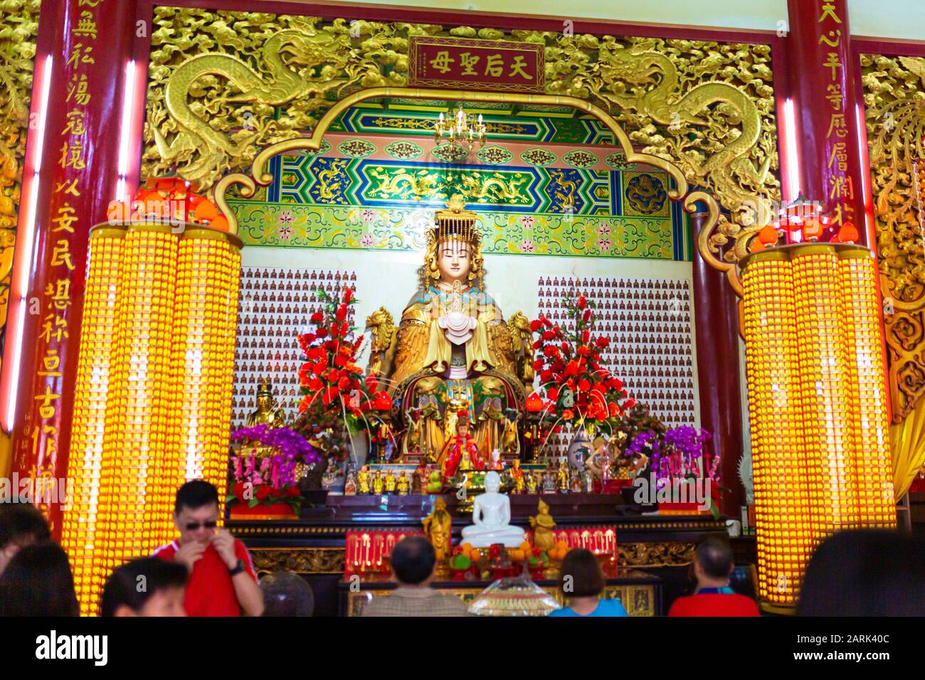 Deity statue in a Chinese temple with offerings Stock Photo - Alamy