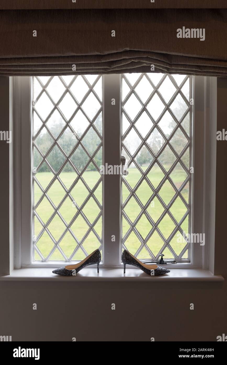 brides wedding shoes on window seal backlit Stock Photo - Alamy
