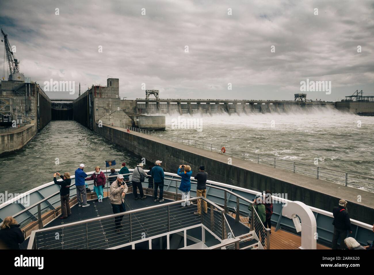 A group of tourists travel through the locks at a dam Stock Photo - Alamy