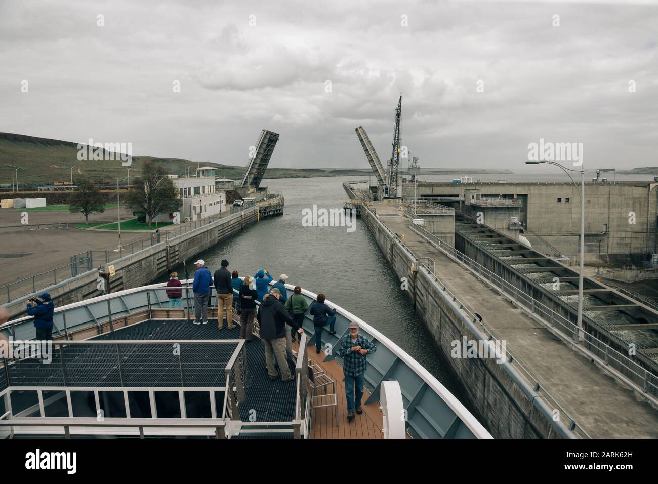 A group of tourists travel through the locks at a dam Stock Photo - Alamy