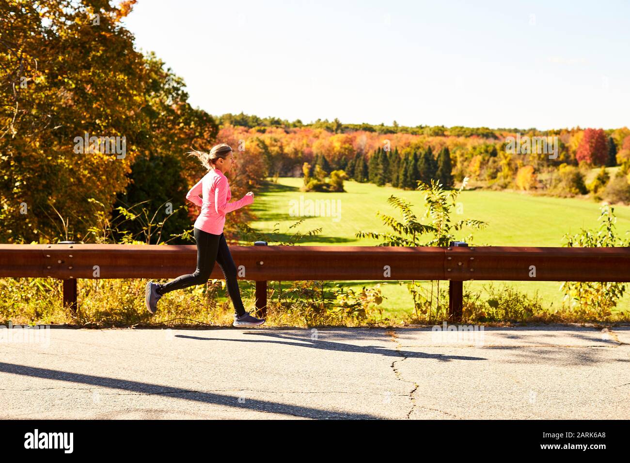Female runner on country road hi-res stock photography and images - Alamy