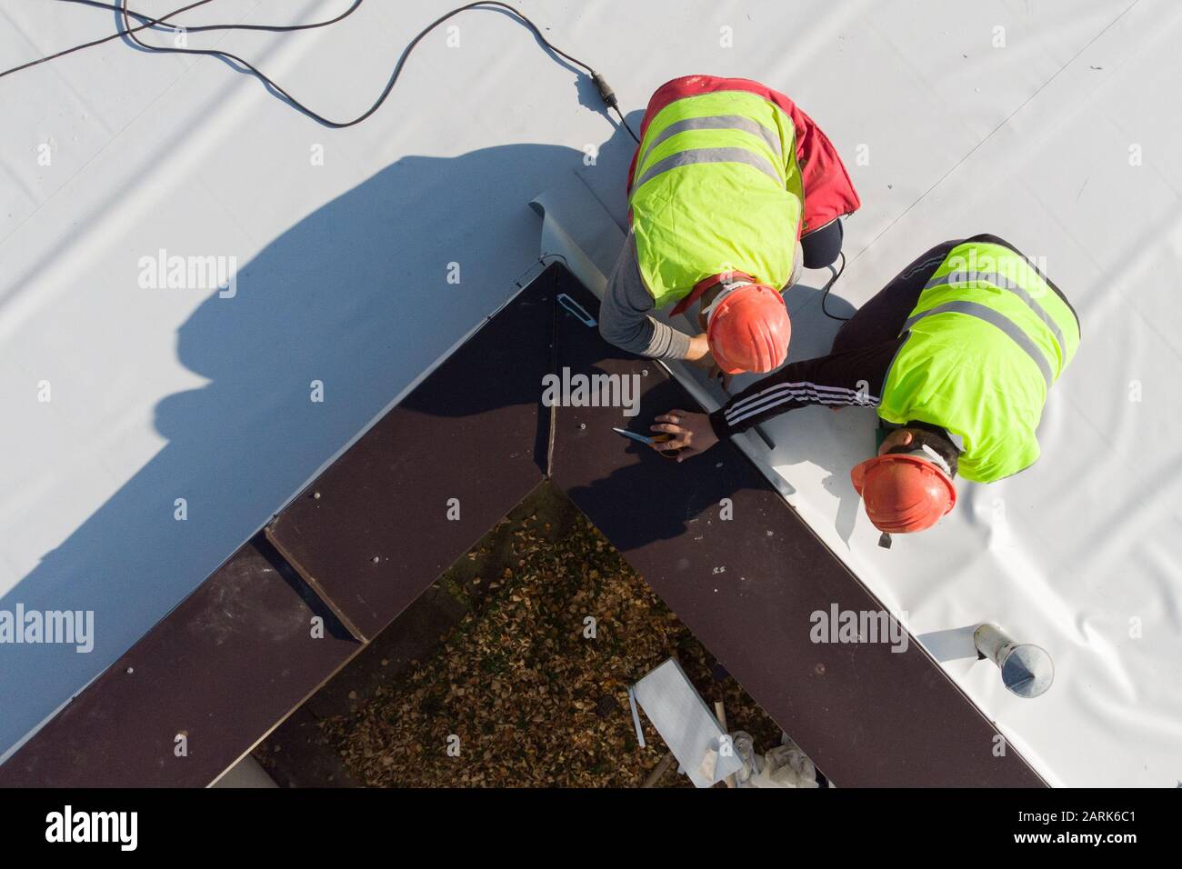 Aerial shot of construction workers on flat rooftop Stock Photo - Alamy