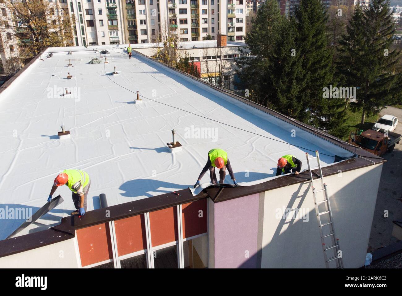 Aerial shot of construction workers on flat rooftop Stock Photo - Alamy