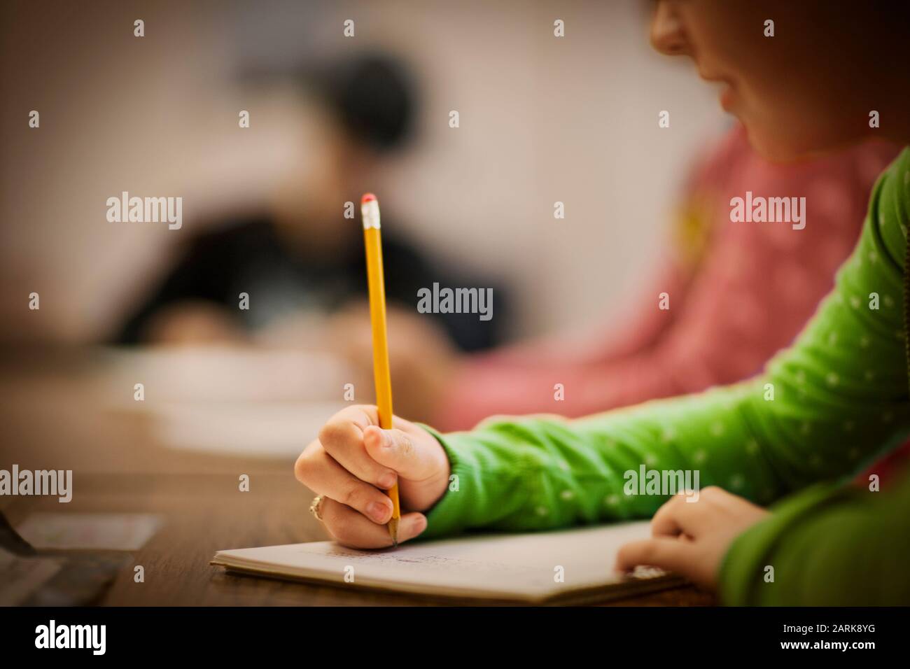 Writing being done by a teenage girl in a classroom Stock Photo - Alamy
