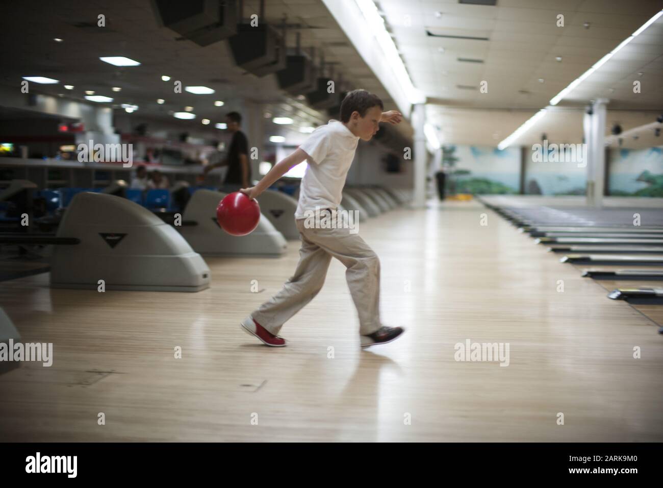 Boy bowling in bowling alley Stock Photo - Alamy