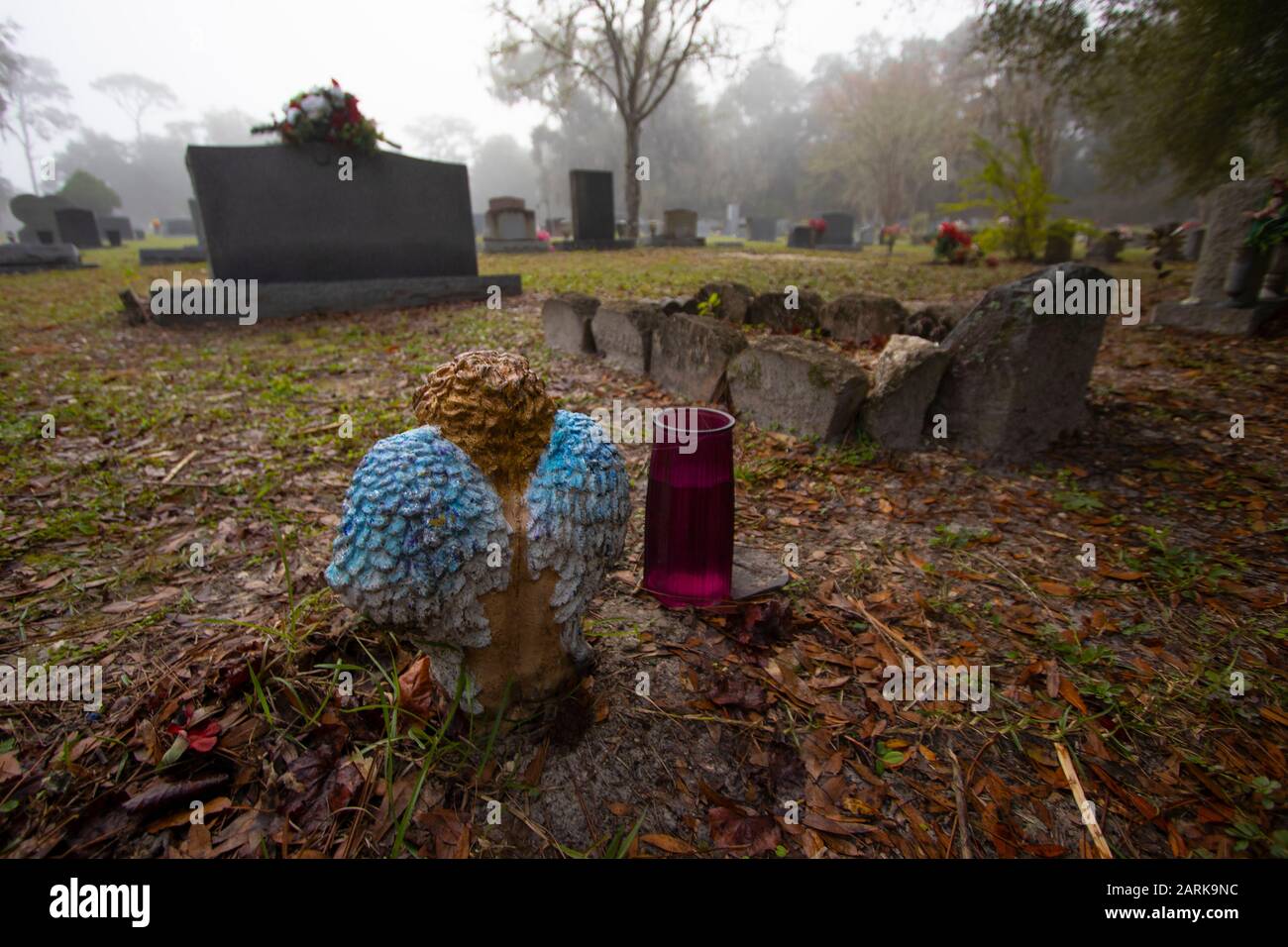 Blue wings on a child angel statue in a cemetery Stock Photo - Alamy