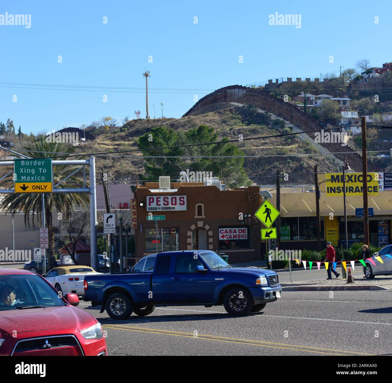 A view of downtown Nogales, AZ, with storefronts in foreground and ...