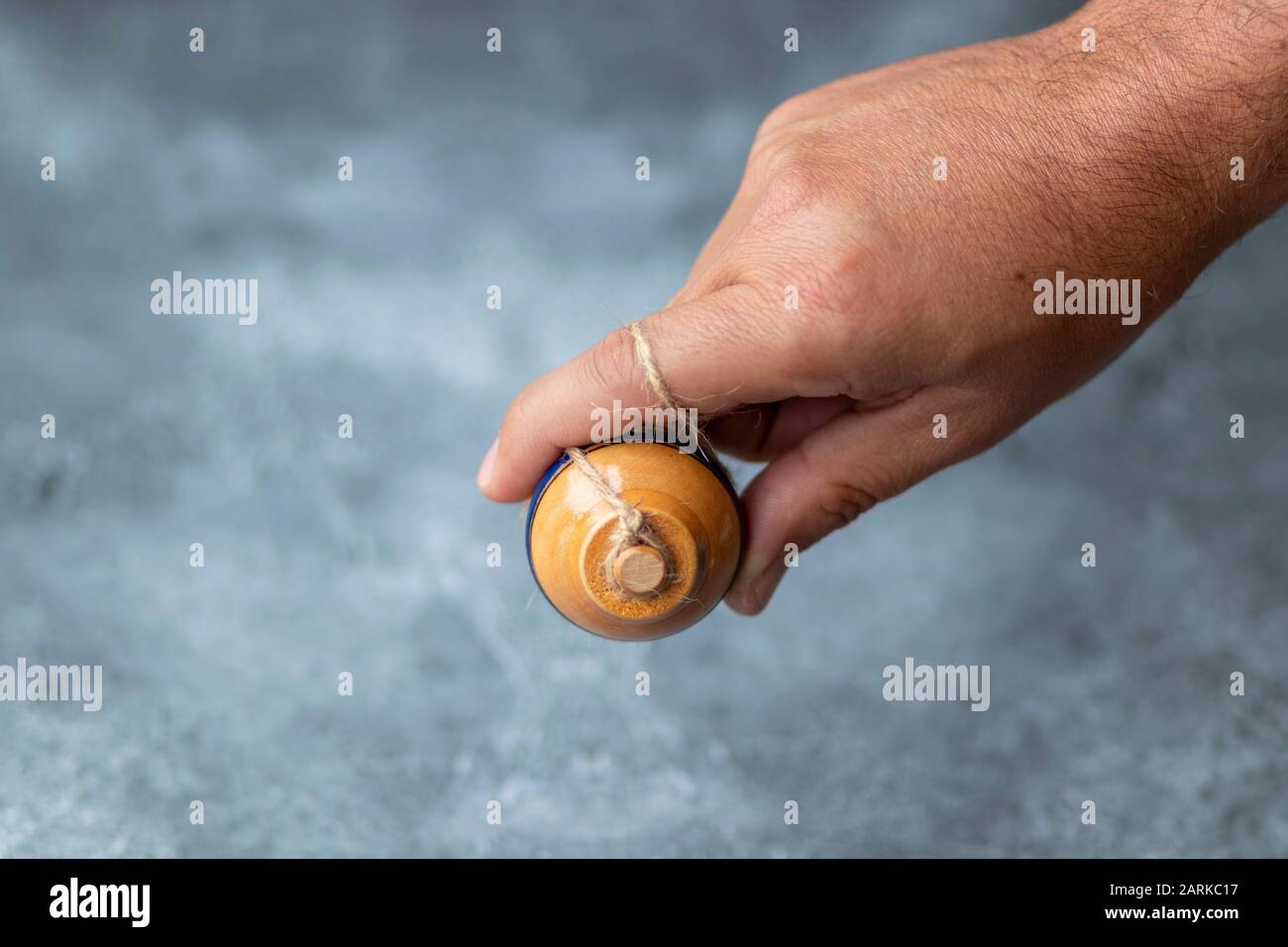 Classic wooden spinning top toy with string Stock Photo - Alamy