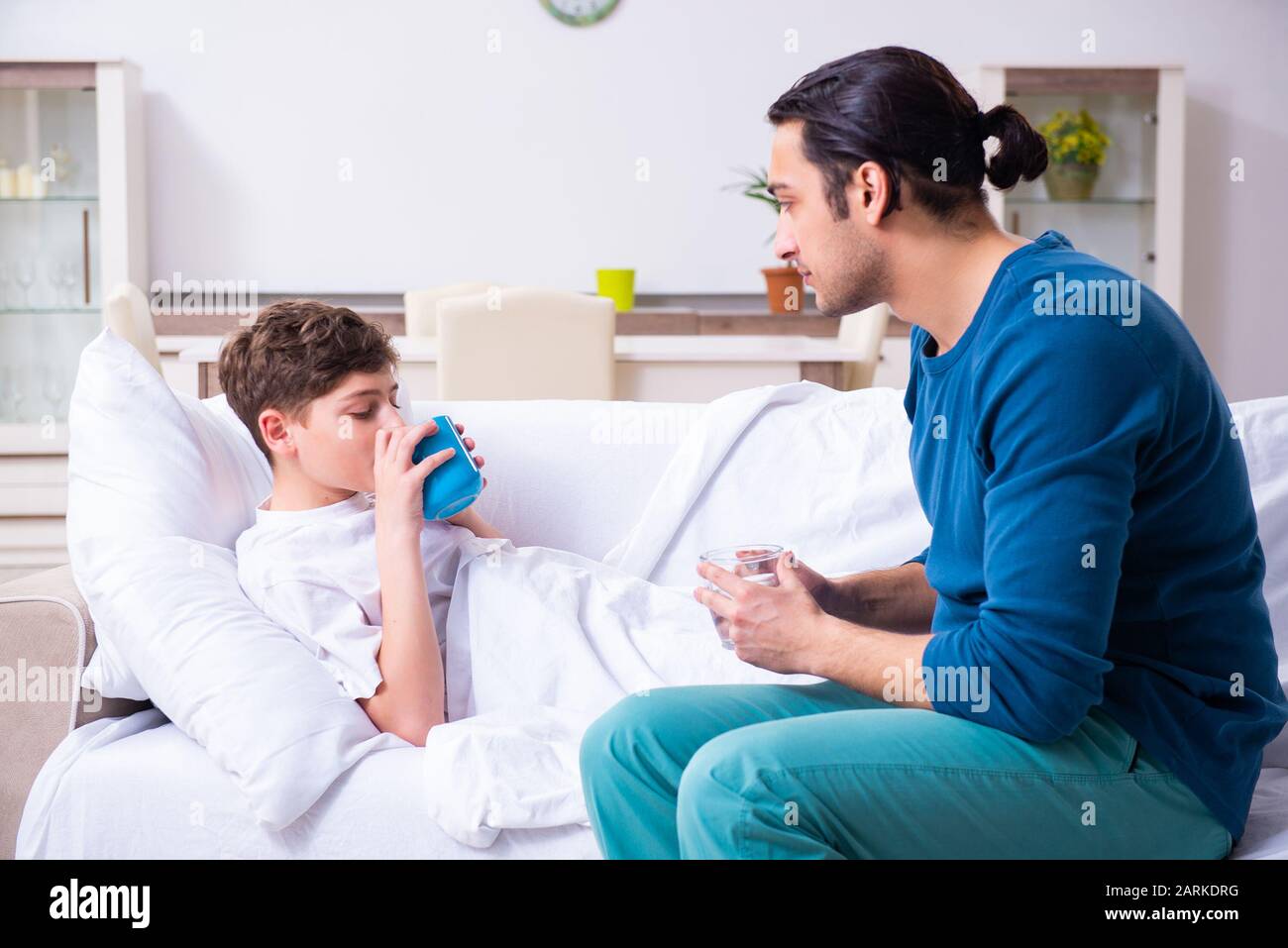 The young father caring for sick son Stock Photo - Alamy