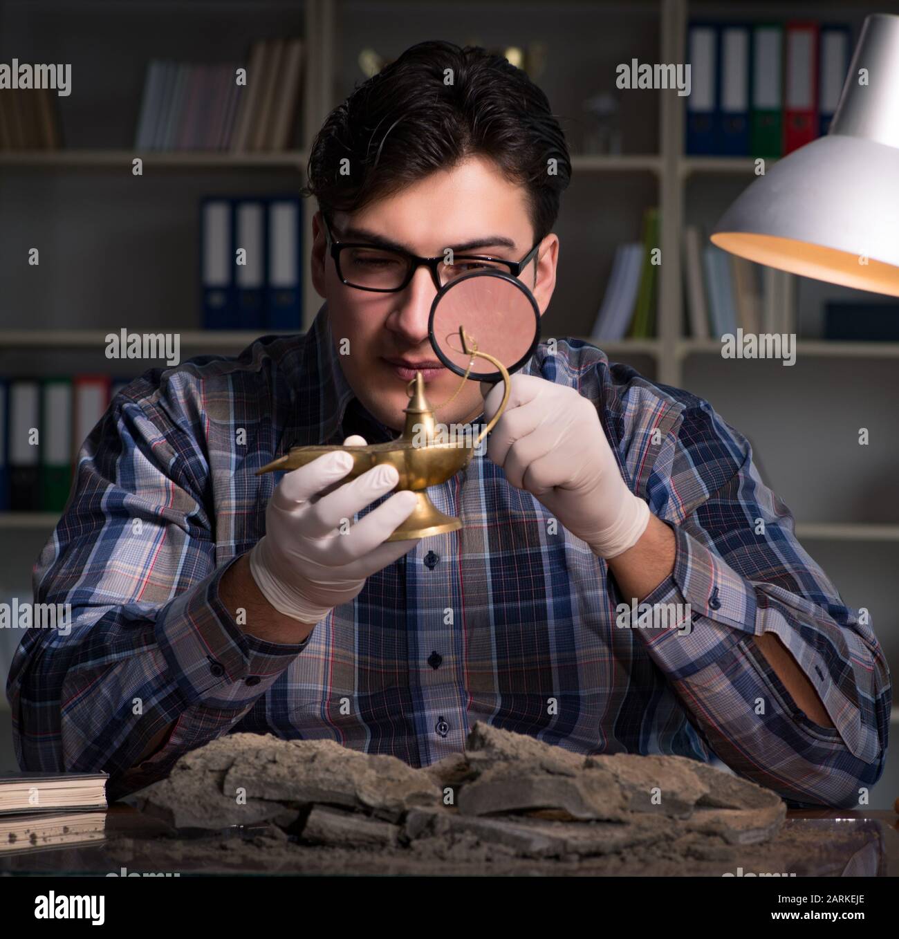 The archeologist working late night in office Stock Photo - Alamy