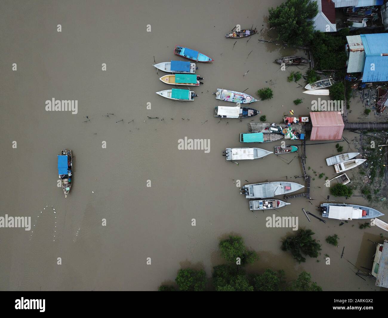 A top down view of a group of fishing vessels or boats in a port or ...