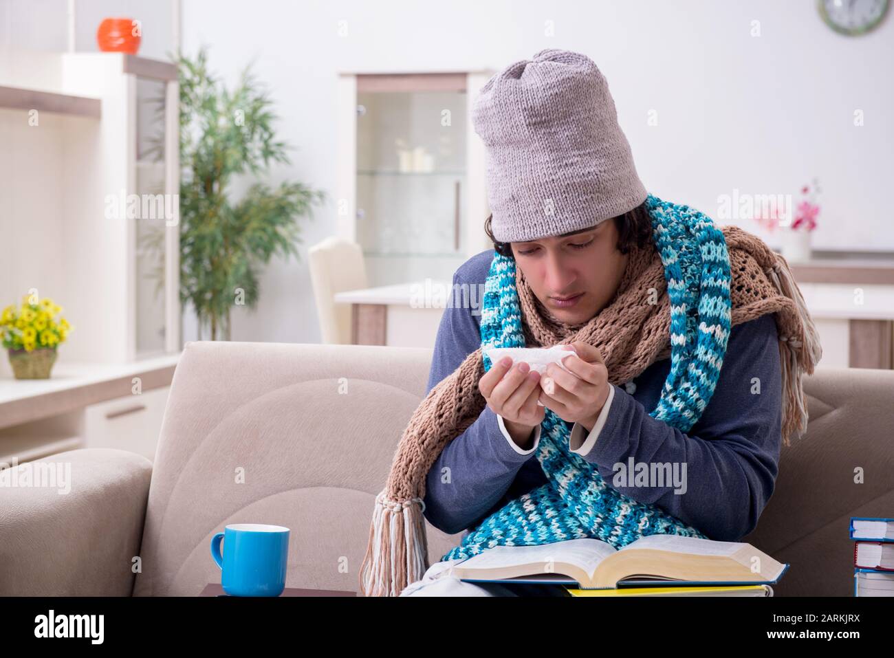 The sick male student suffering at home Stock Photo - Alamy