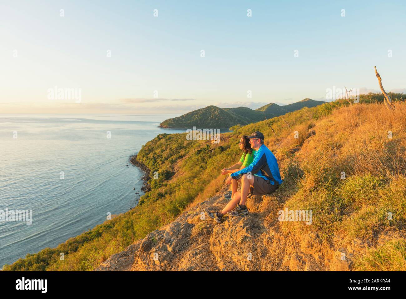 Couple watching island view at sunset, Drawaqa Island, Yasawa island ...