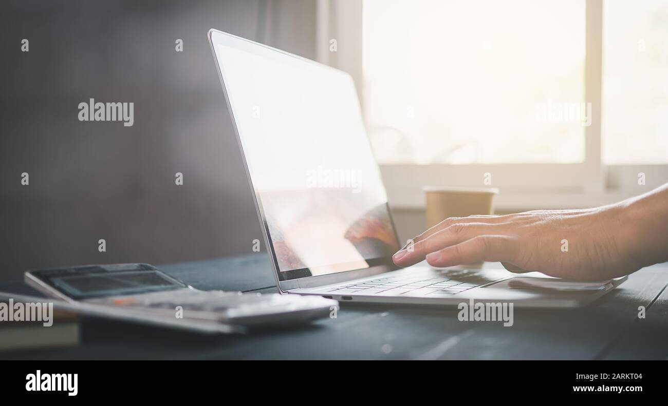 part of human hand while using laptop at working desk Stock Photo - Alamy