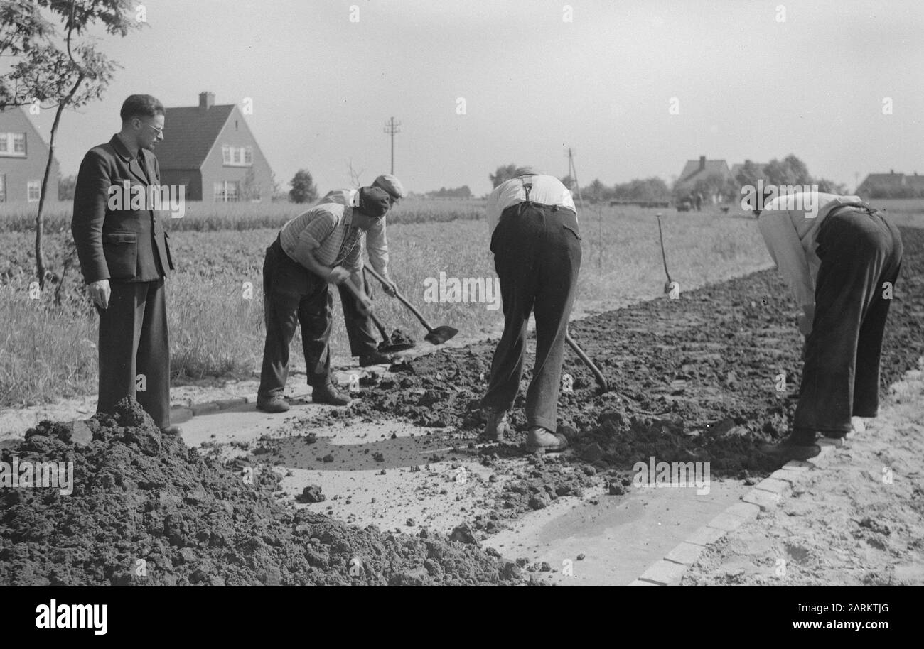 road construction, workers, houses Date: undated Keywords: workers ...