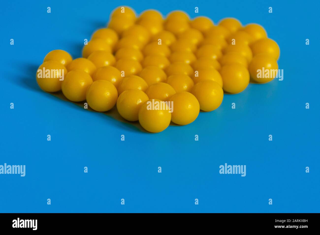 Yellow vitamins on a blue background. Vitamin complex against the virus ...