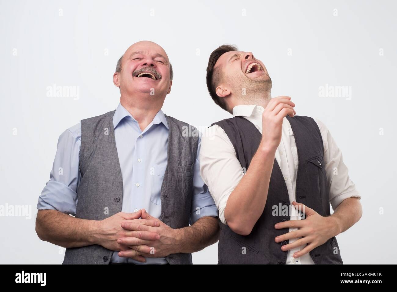 Two caucasian men laughing on his friends joke. Studio shot Stock Photo ...