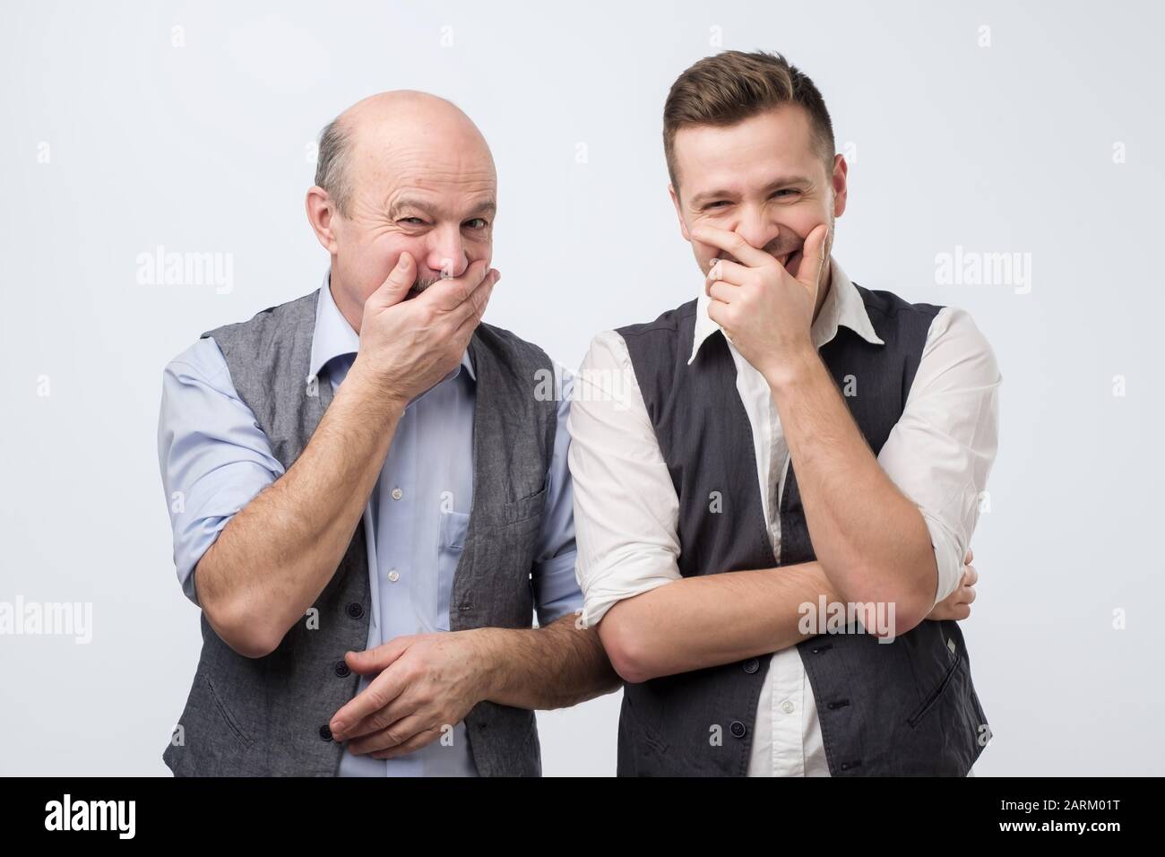 Two caucasian men laughing on his friends joke. Studio shot Stock Photo ...