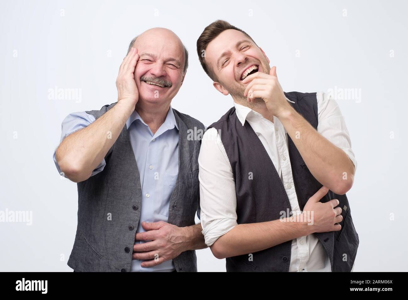 Two caucasian men laughing on his friends joke. Studio shot Stock Photo ...