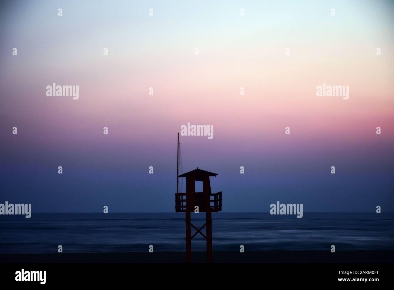 old wooden lifeguard house with sunset background Stock Photo - Alamy