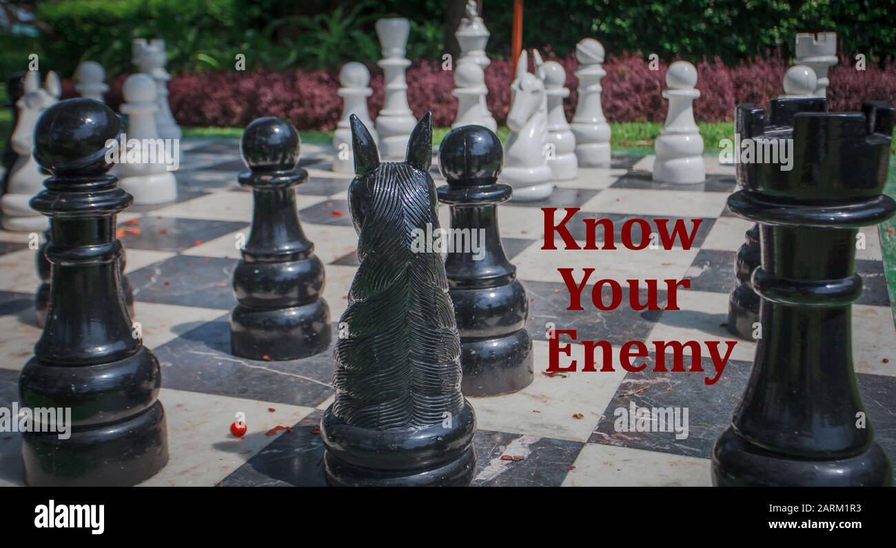 Giant chess game in park with text: Know your enemy Stock Photo - Alamy