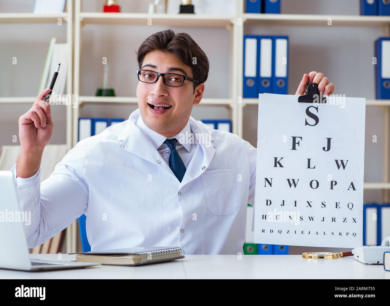 The doctor optician with letter chart conducting an eye test check ...