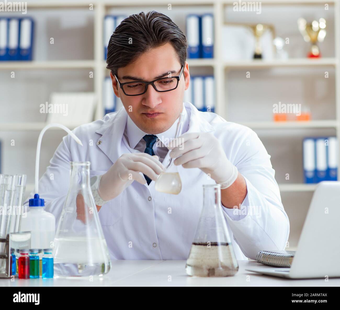 Young researcher scientist doing a water test contamination experiment ...