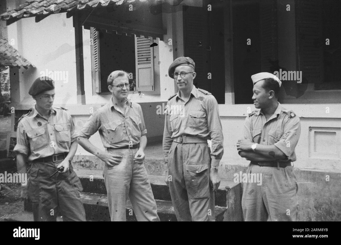 Poerwokerto-Banjoemas Four men, three soldiers standing in front of a ...