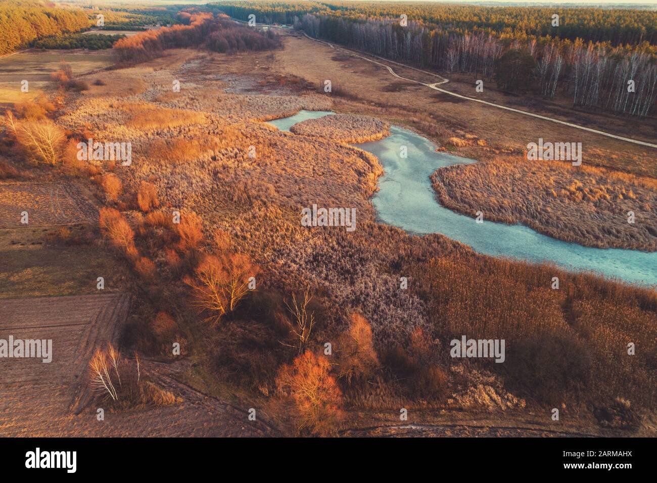 View from above of the countryside and frozen brook. Rural nature ...
