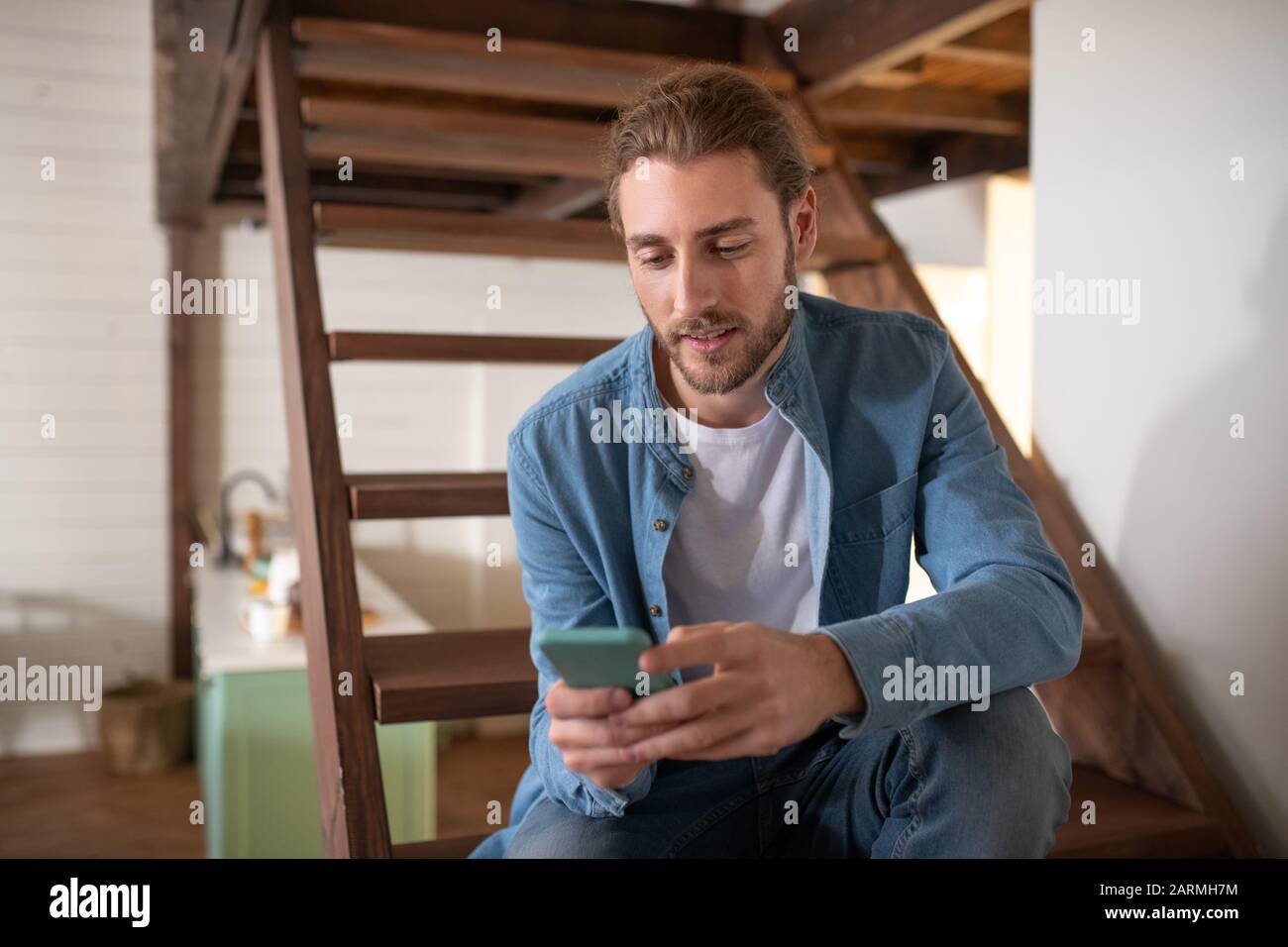 Handsome man typing a message to his partner Stock Photo - Alamy