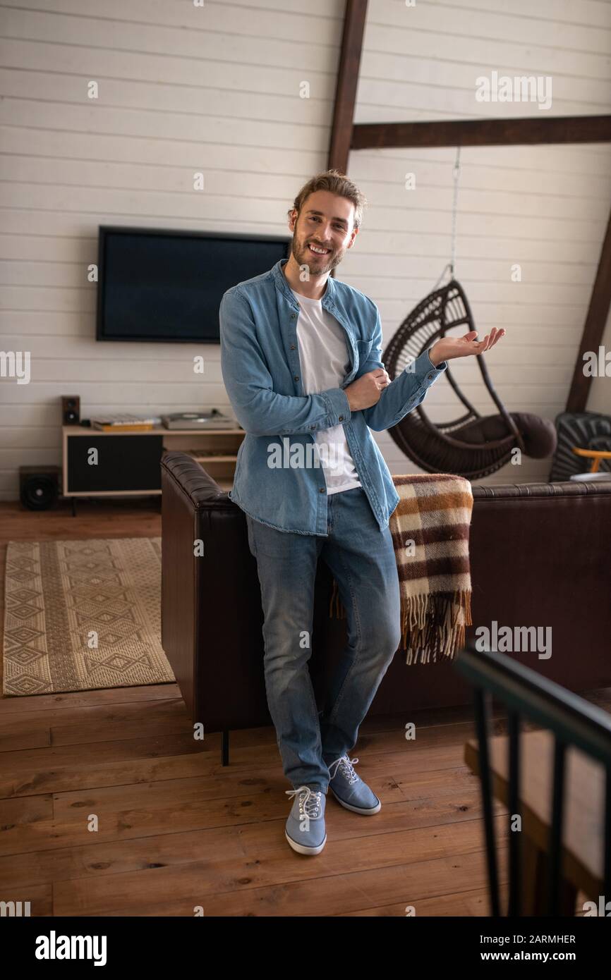 Handsome welcoming man smiling hi-res stock photography and images - Alamy