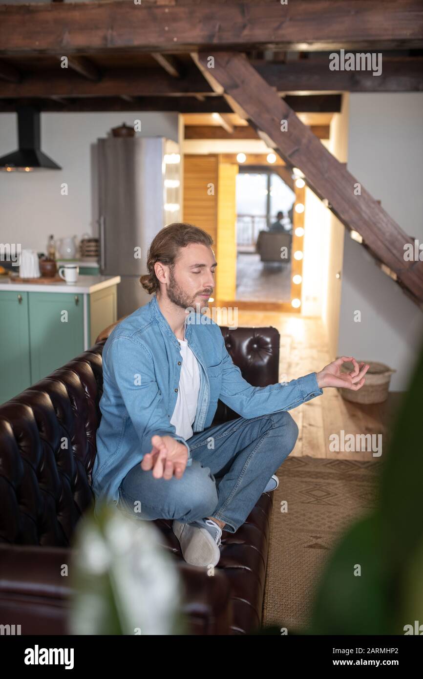 Relaxed man doing everyday meditation at home Stock Photo - Alamy